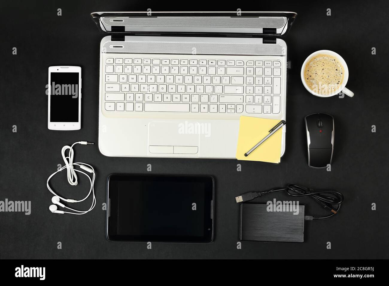 top view of desk with laptop and other objects, technology concept ...