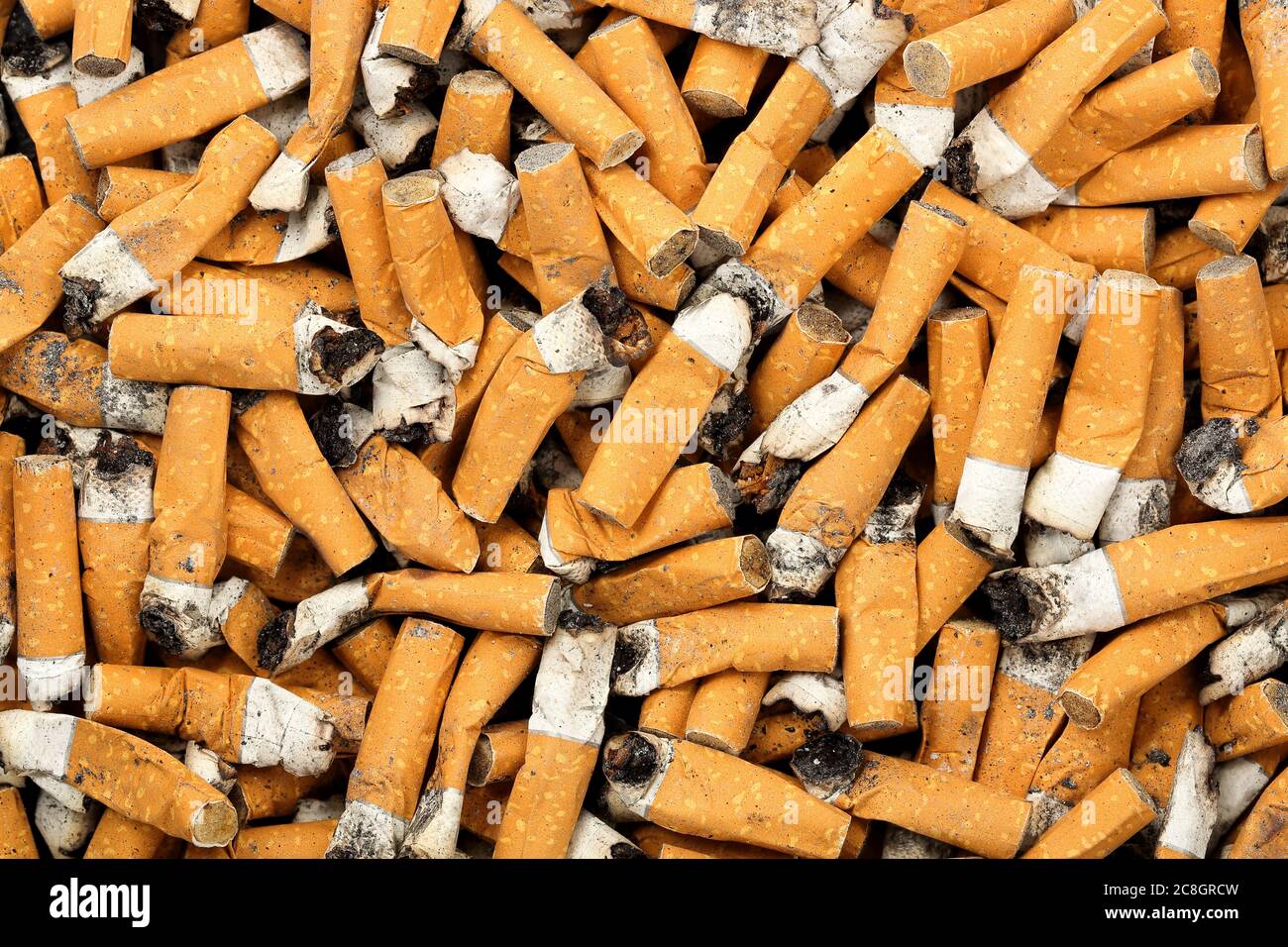 many cigarette butts for background use Stock Photo - Alamy