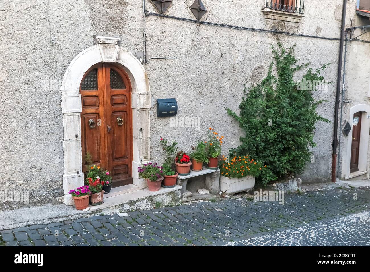 Old wooden door at the entrance of a medieval Italian house, with ...
