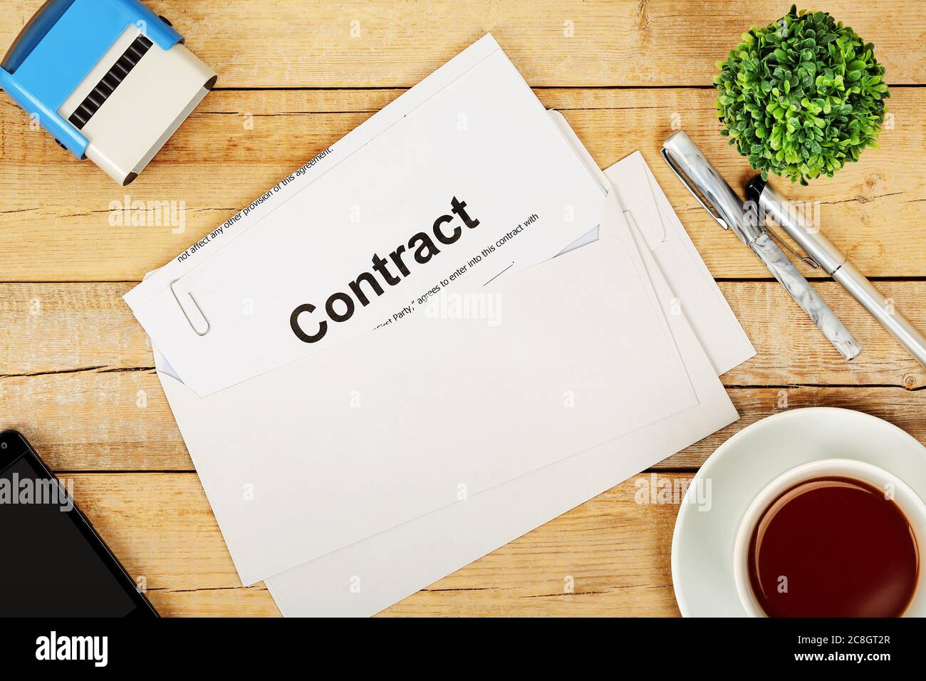 envelope with contract on wooden desk, top view Stock Photo - Alamy