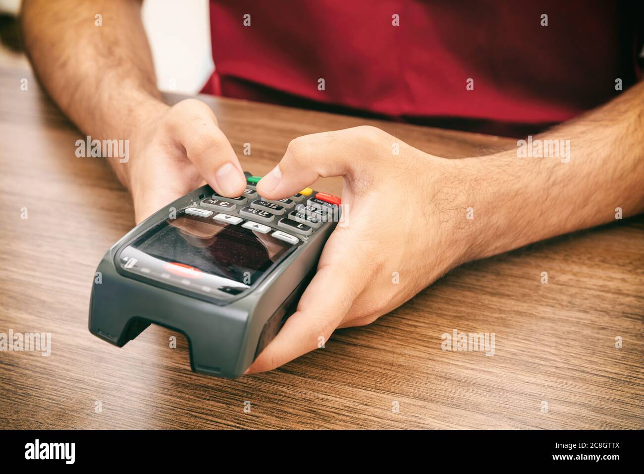 Man holding a payment swipe machine and typing, closeup view. Credit ...
