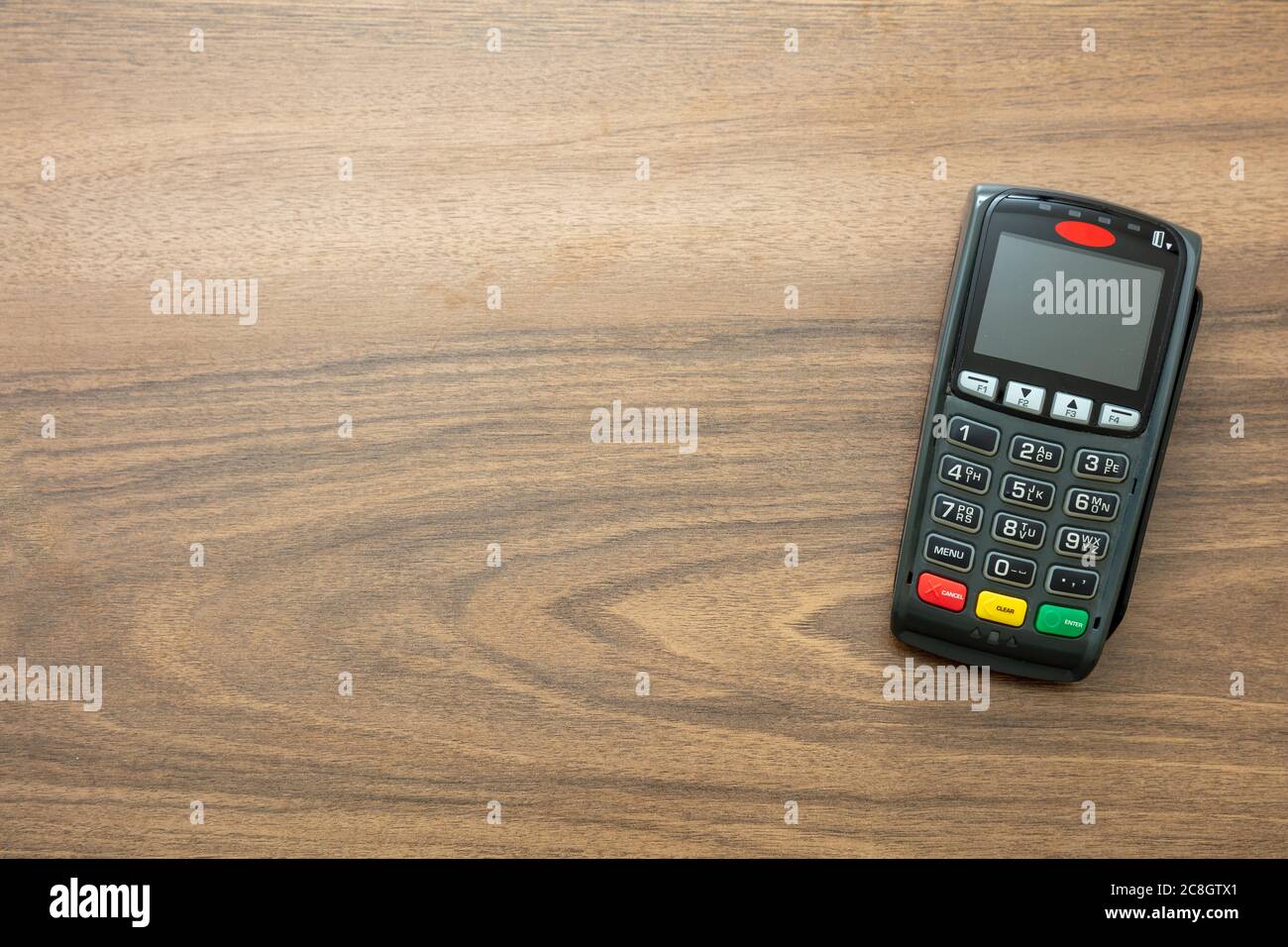 POS terminal isolated on wooden background, top view.Terminal cash ...