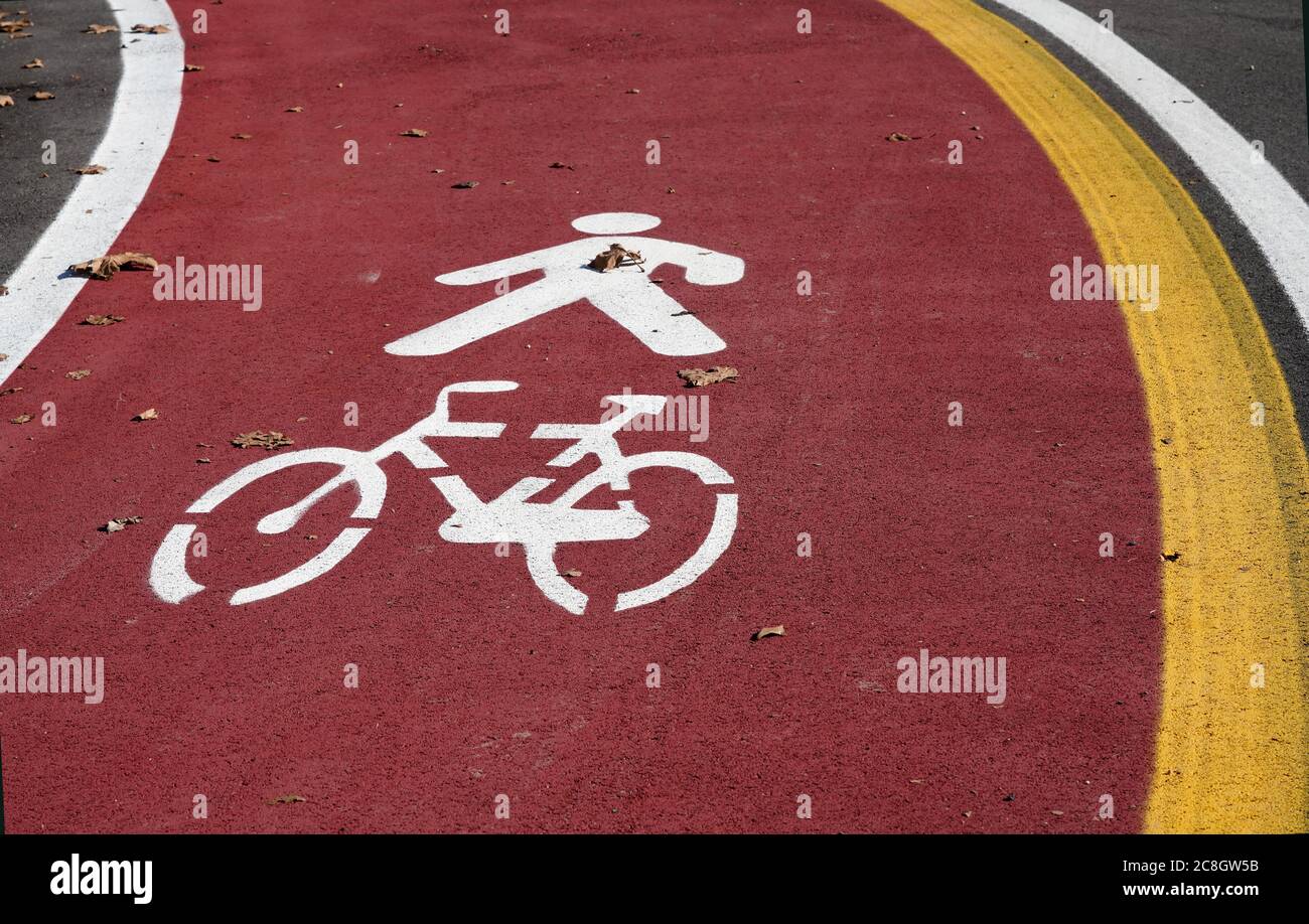 Red marked path for pedestrians and cyclists Stock Photo - Alamy