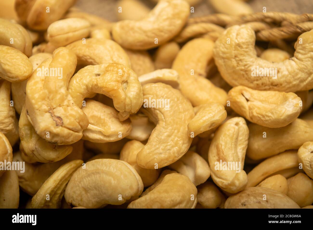 Cashew nuts scattered surface texture. Close up Stock Photo - Alamy