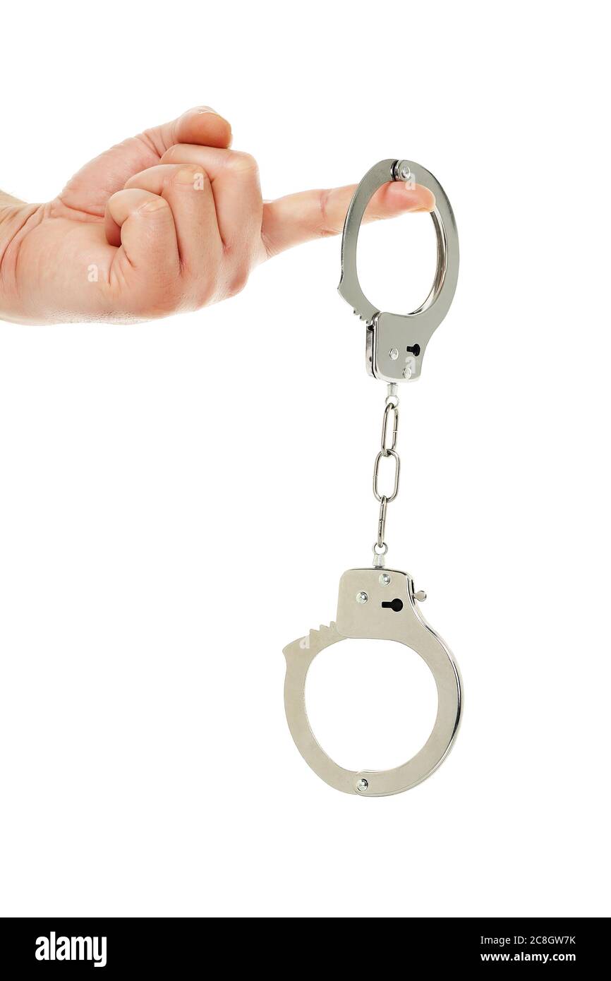 hand holding handcuffs isolated on white Stock Photo - Alamy