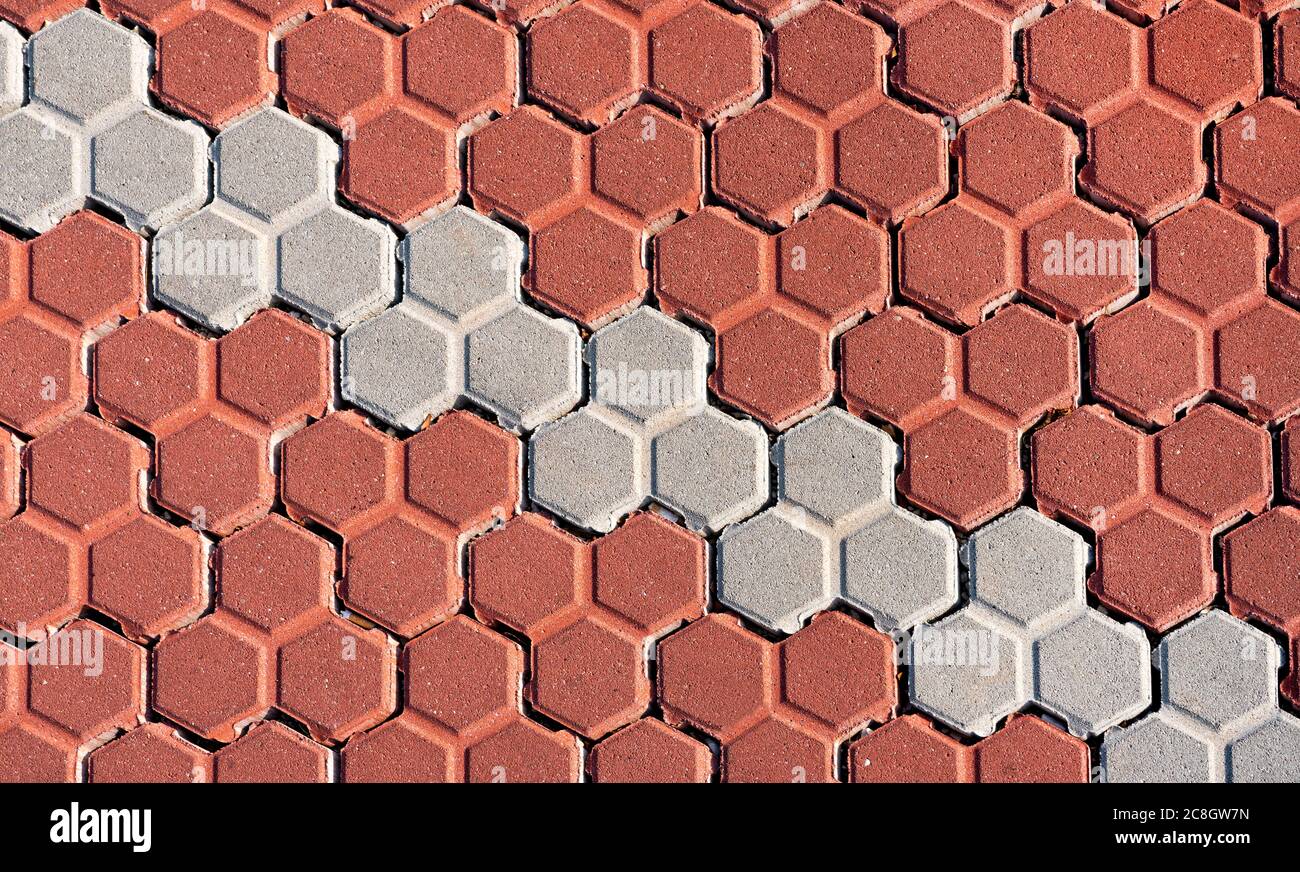 Pavement with white and red hexagon pattern. Cement sidewalk with ...