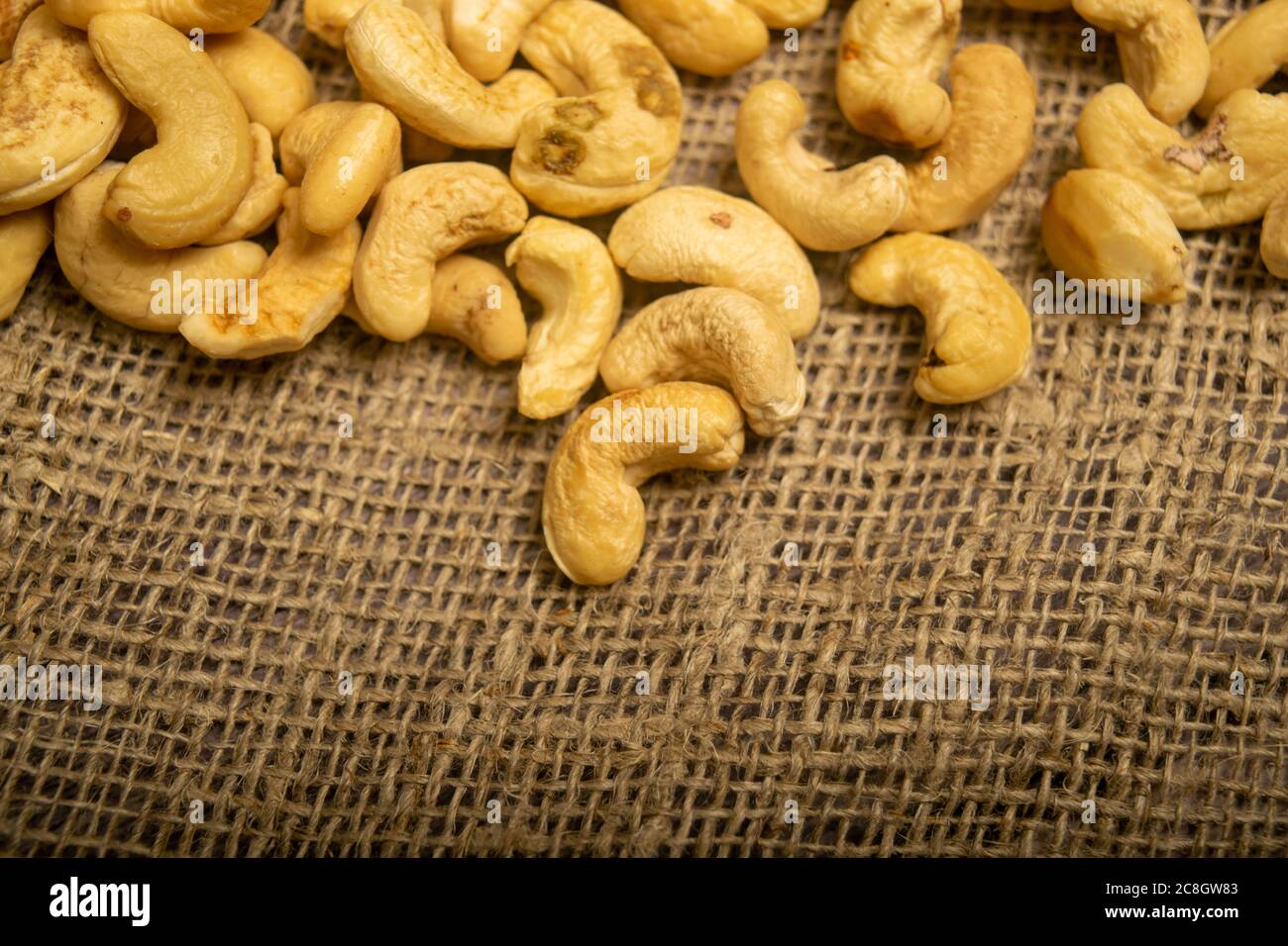 A pile of cashew nuts on burlap with a rough texture surface texture ...