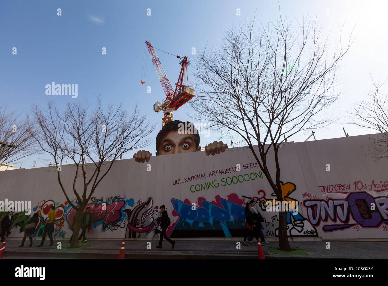 Fence with graffiti with Man observing in location before MMCA ...