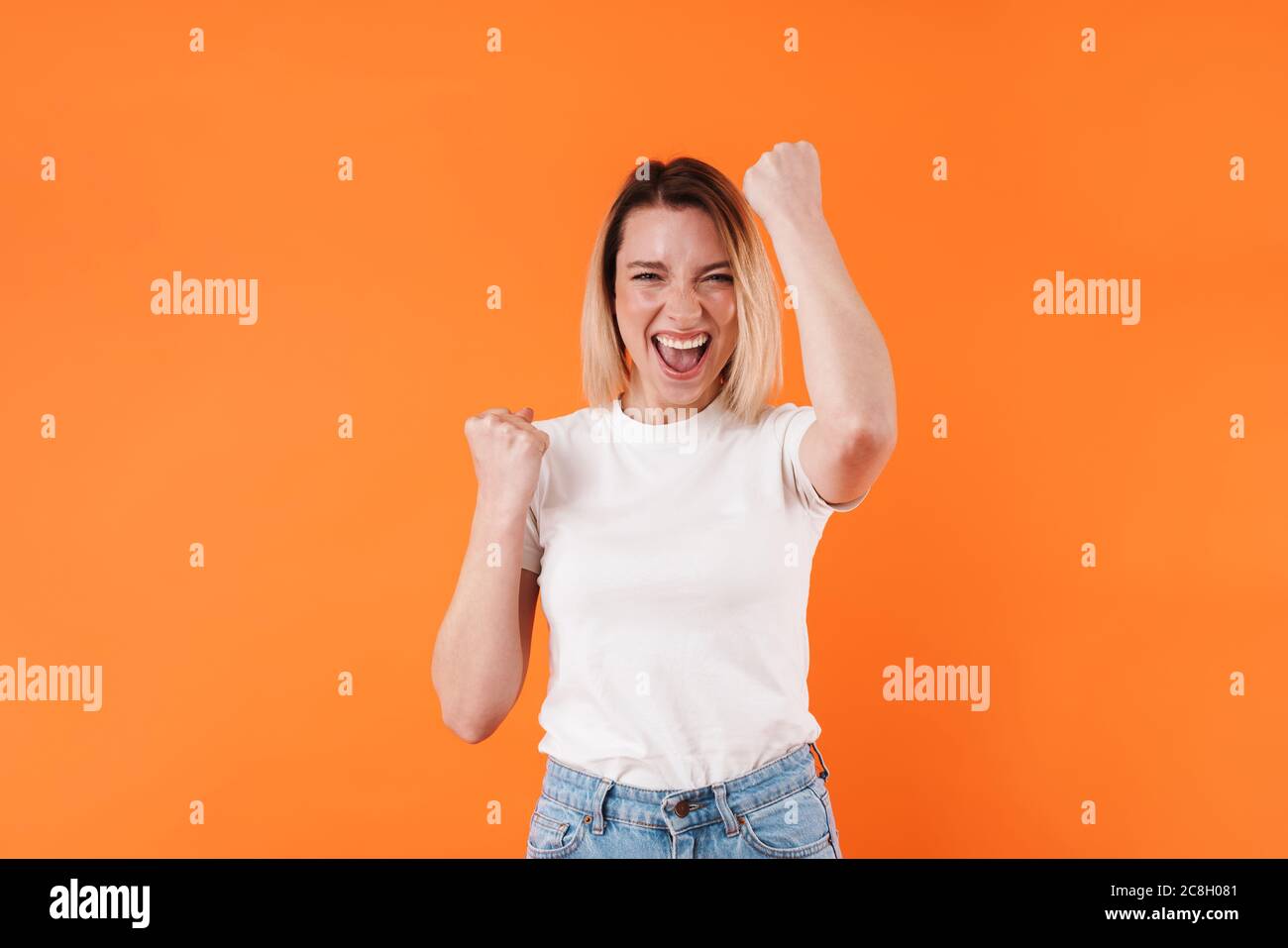 Image of young delighted woman laughing and making winner gesture ...