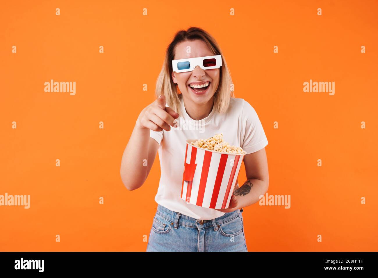 Image of laughing woman in 3d glasses pointing finger at camera while ...