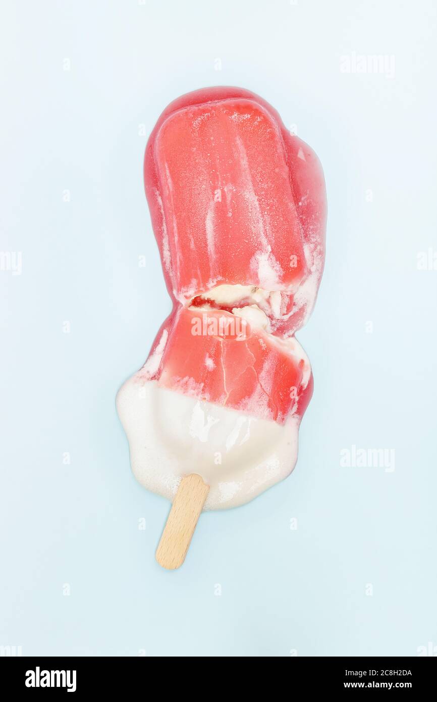 closeup of melted popsicle on light blue surface Stock Photo - Alamy