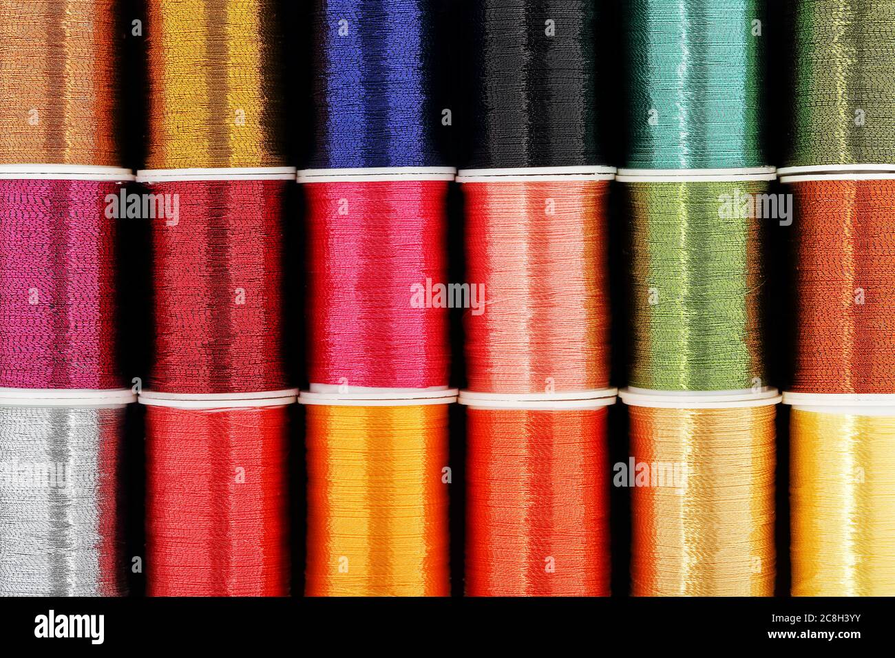 colorful spools of thread as a background Stock Photo - Alamy