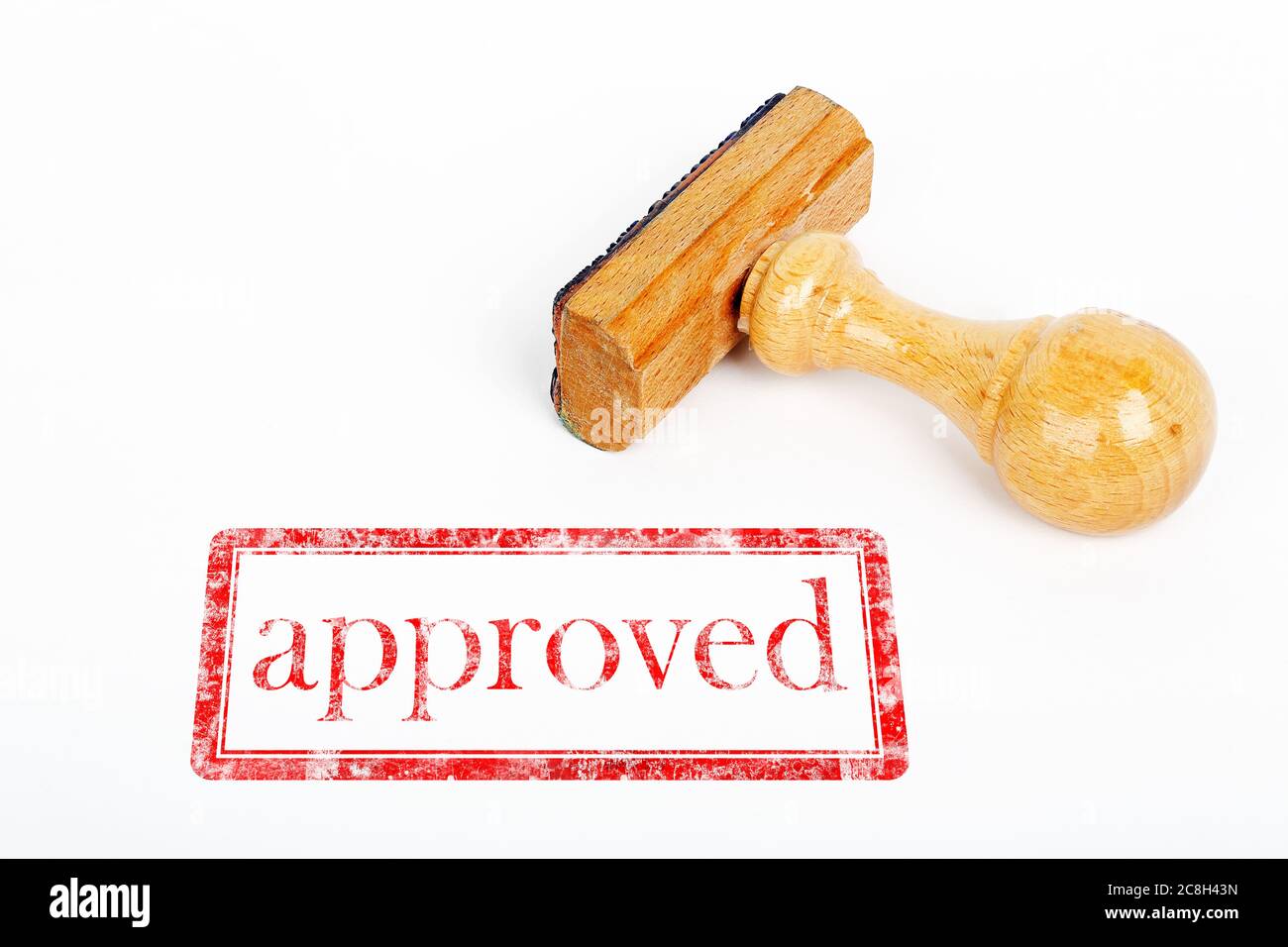 office rubber stamp with approved stamp on white paper Stock Photo - Alamy