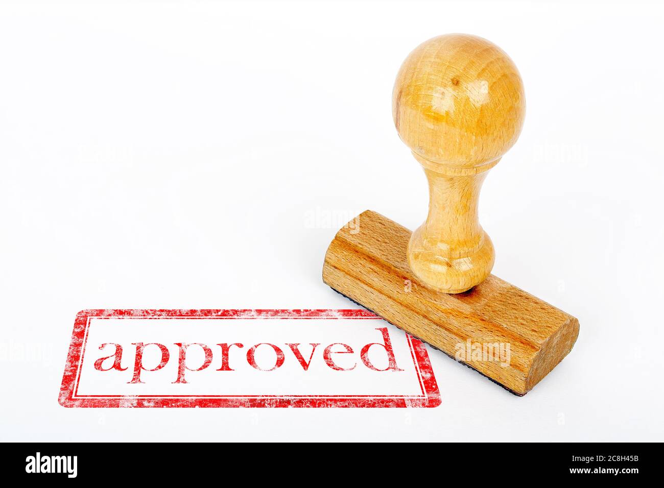 office rubber stamp with approved stamp on white paper Stock Photo - Alamy