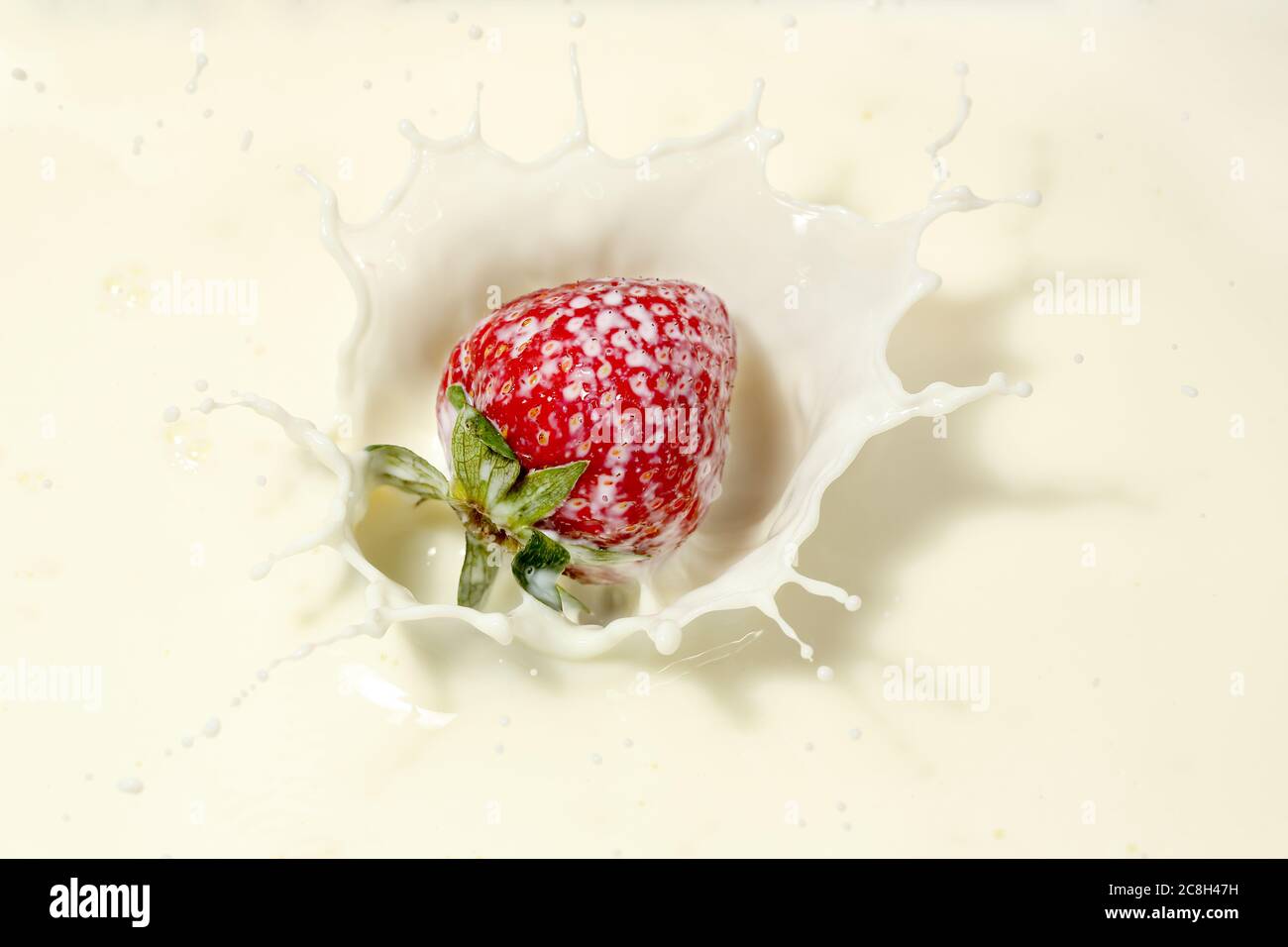 strawberry splashing into fresh milk Stock Photo - Alamy