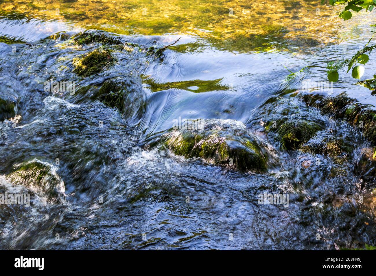 Dove Dale-Flowing water over stones in a nature reserve in England ...