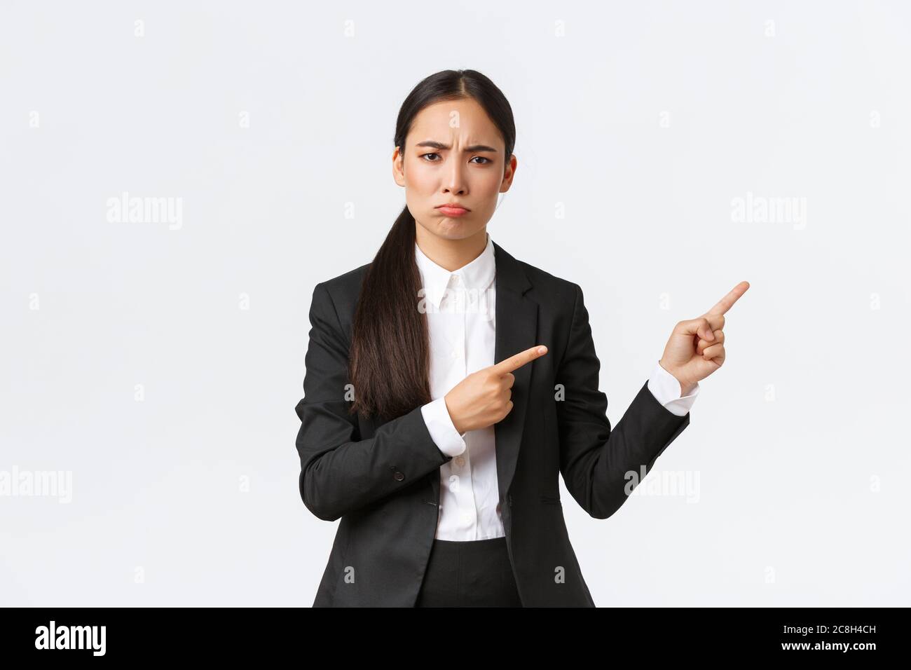Disappointed or jealous female asian entrepreneur in suit complaining ...