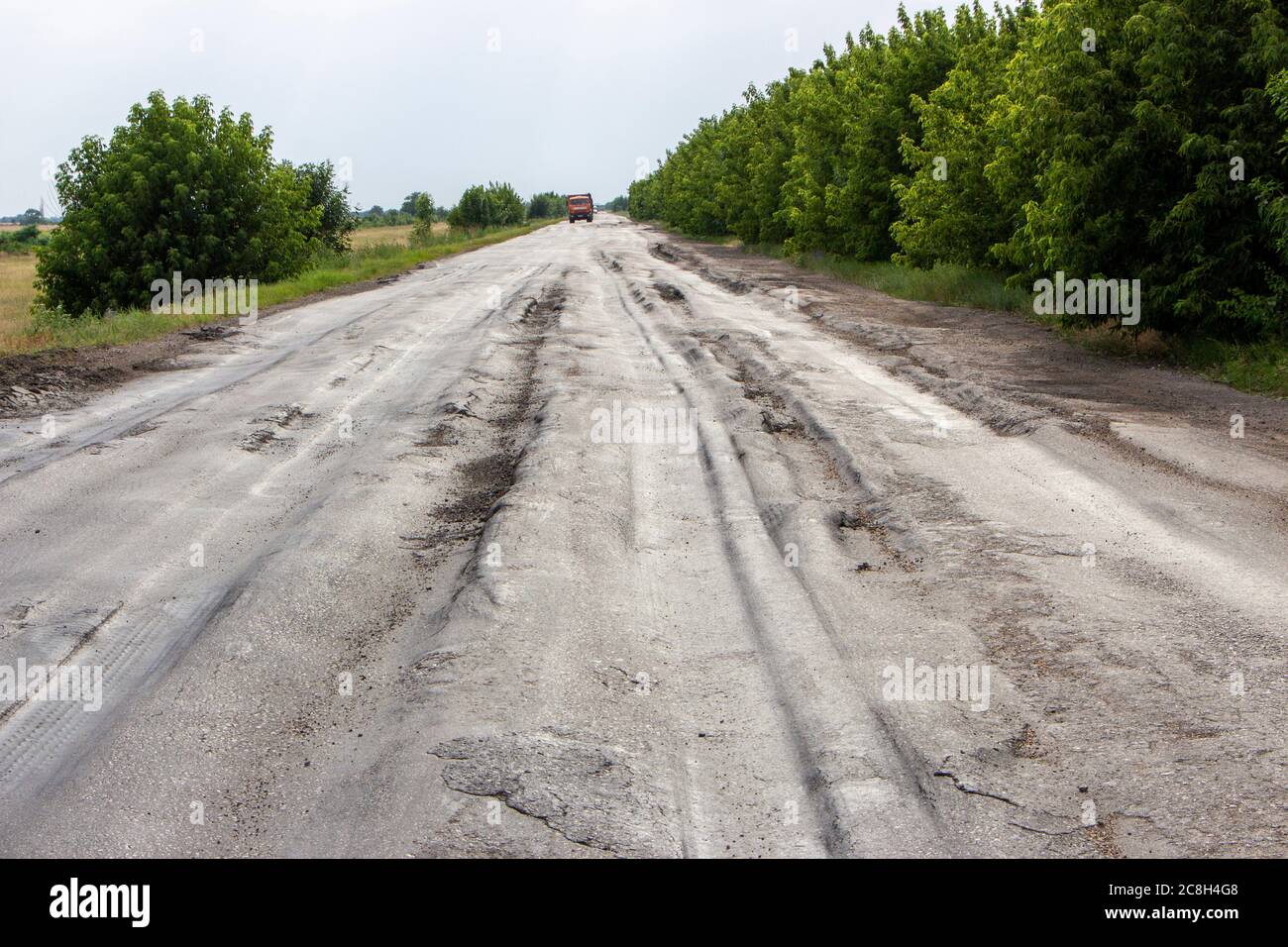 Damaged road by truck. Asphalt pits from heavy trucks. Congestion on ...