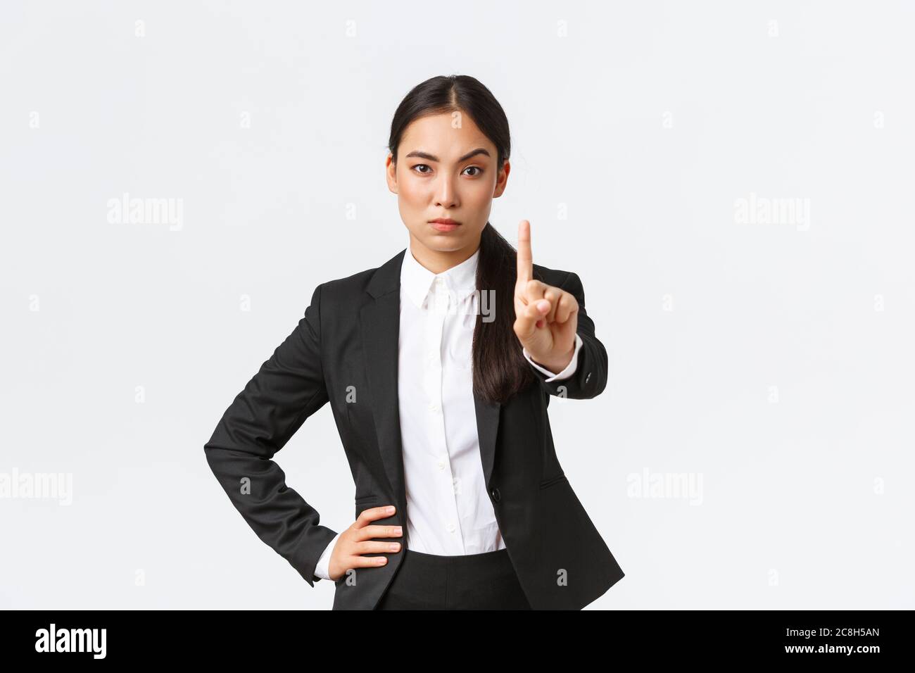 Serious angry asian businesswoman making restriction, give warning sign ...