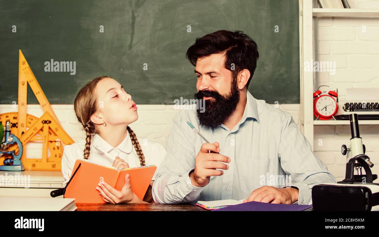 Fascinating lesson. School teacher and schoolgirl. Pedagogue skills ...