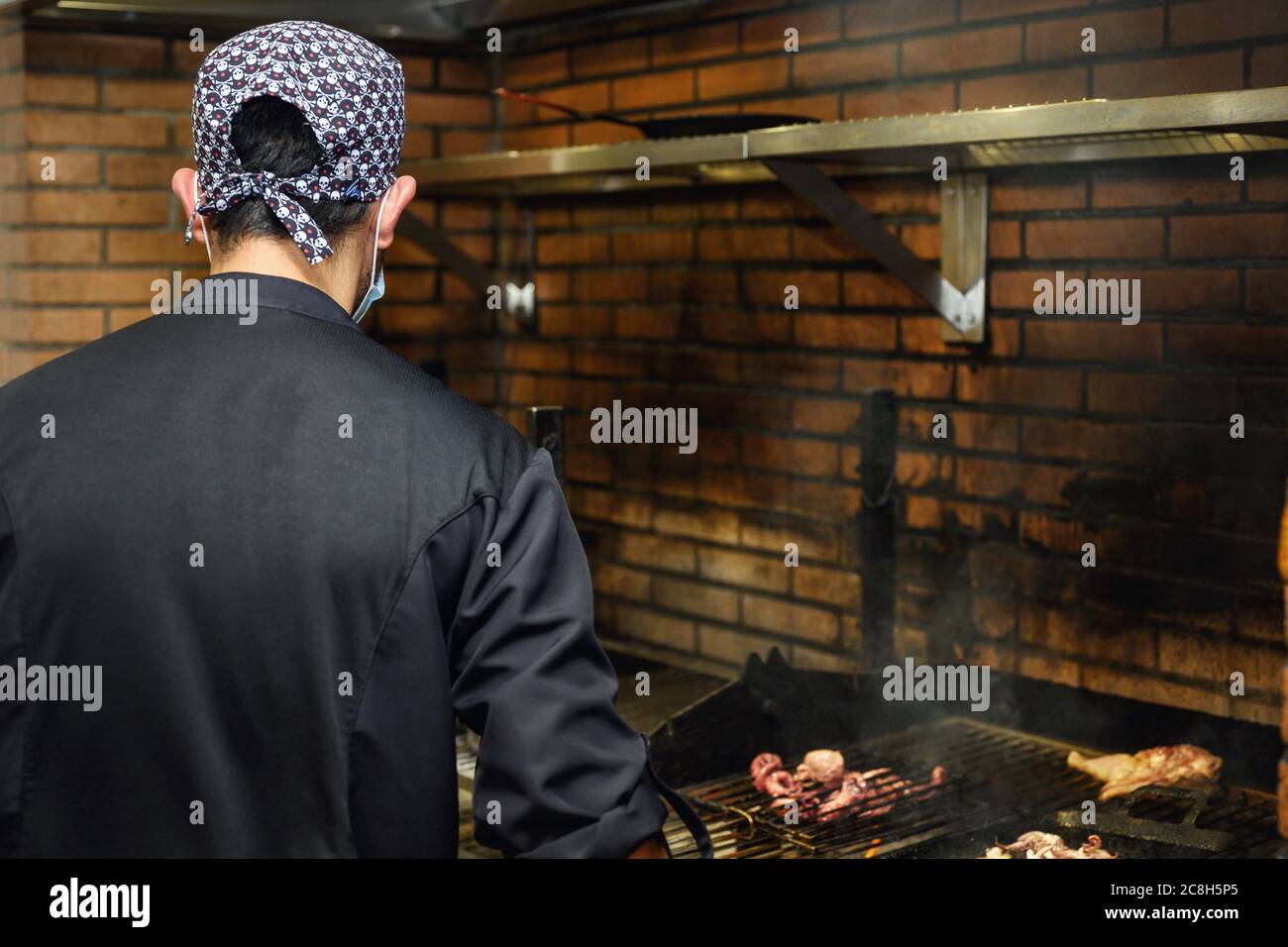 Chef grilling steaks in commercial kitchen. High quality photo Stock ...