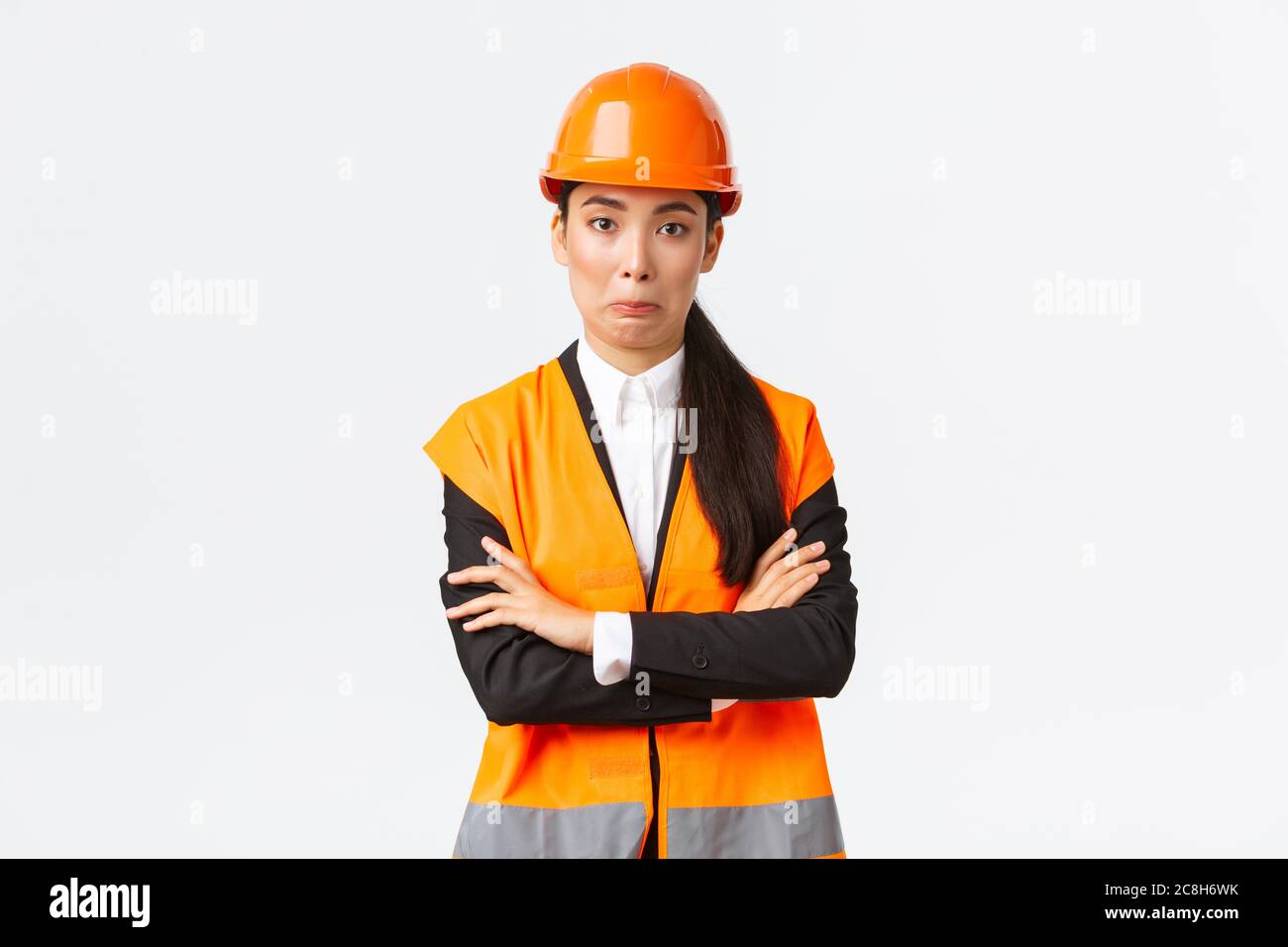 Awkward asian female engineer in reflective jacket, safety helmet ...