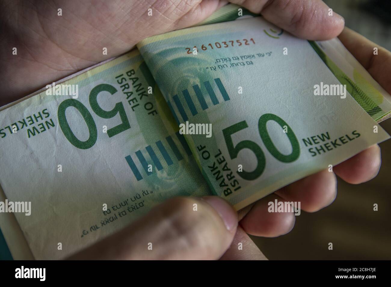 Close-up Hands counting money Israeli shekel Stock Photo - Alamy