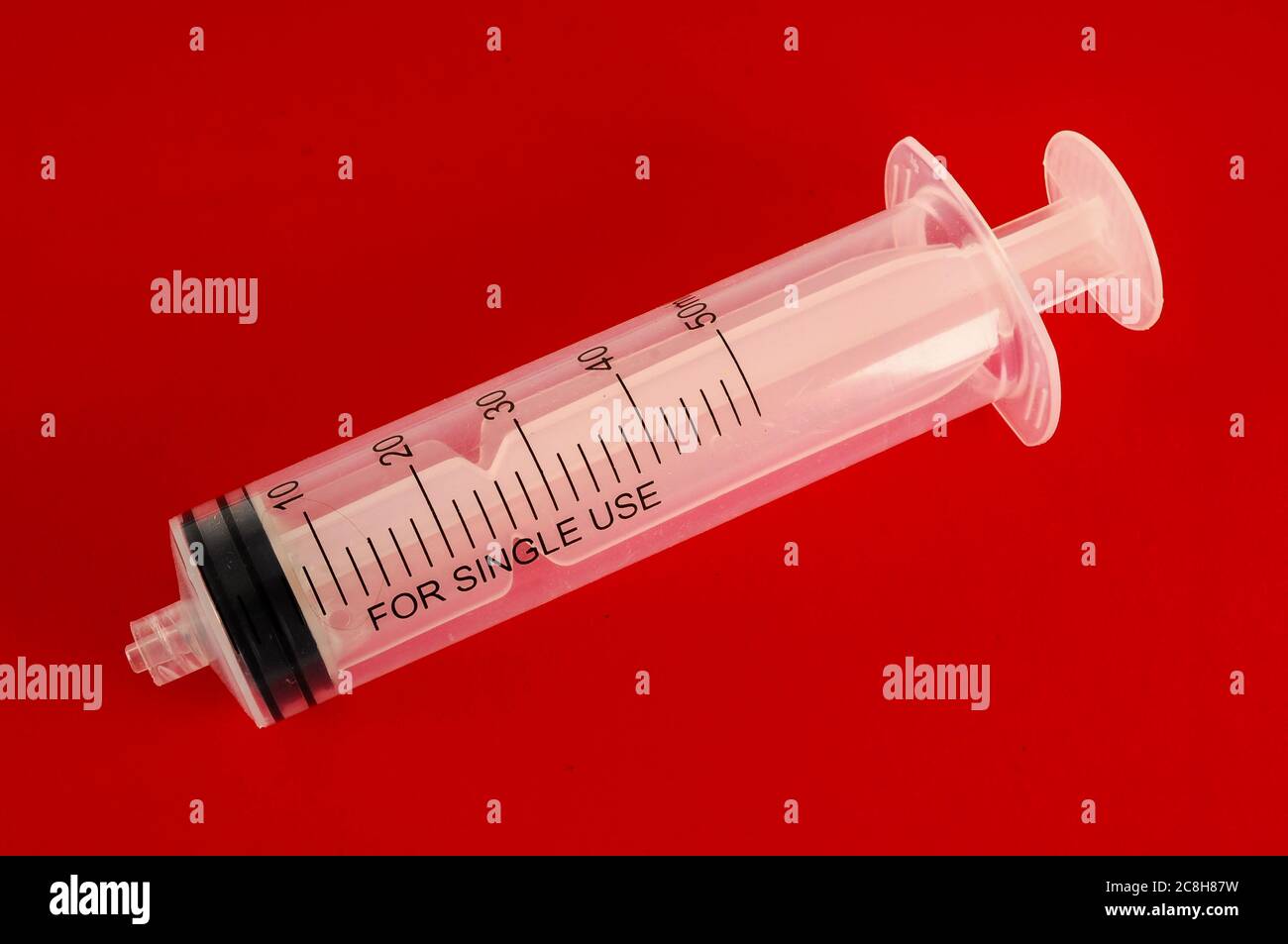 Photo of Syringe closeup isolated on colred background Stock Photo - Alamy