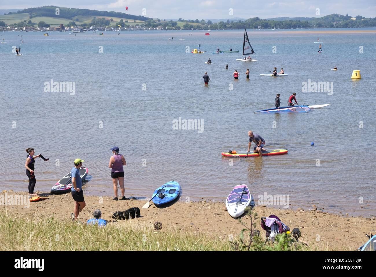 Swimmers, windsurfers and paddle boarders enjoy the Ex estuary in Devon ...