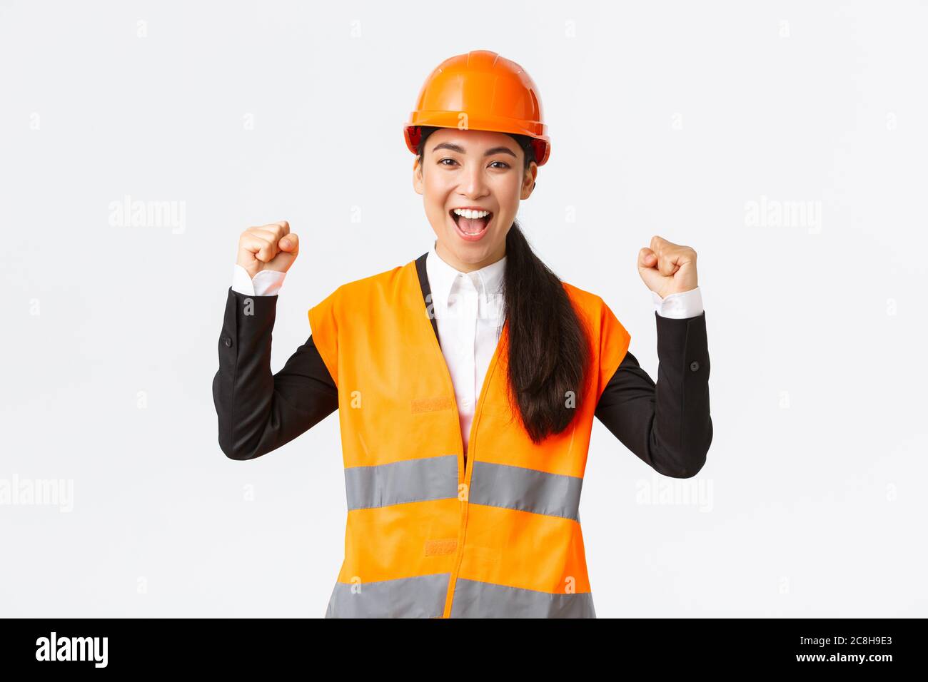 Successful winning female asian engineer fist pump and shout yes ...