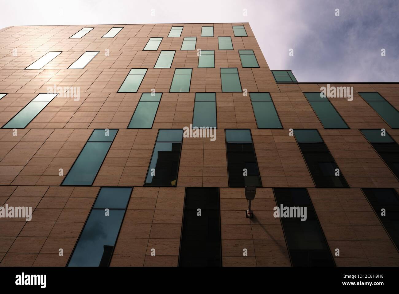 Low angle perspective view of a modern building facade with tall ...