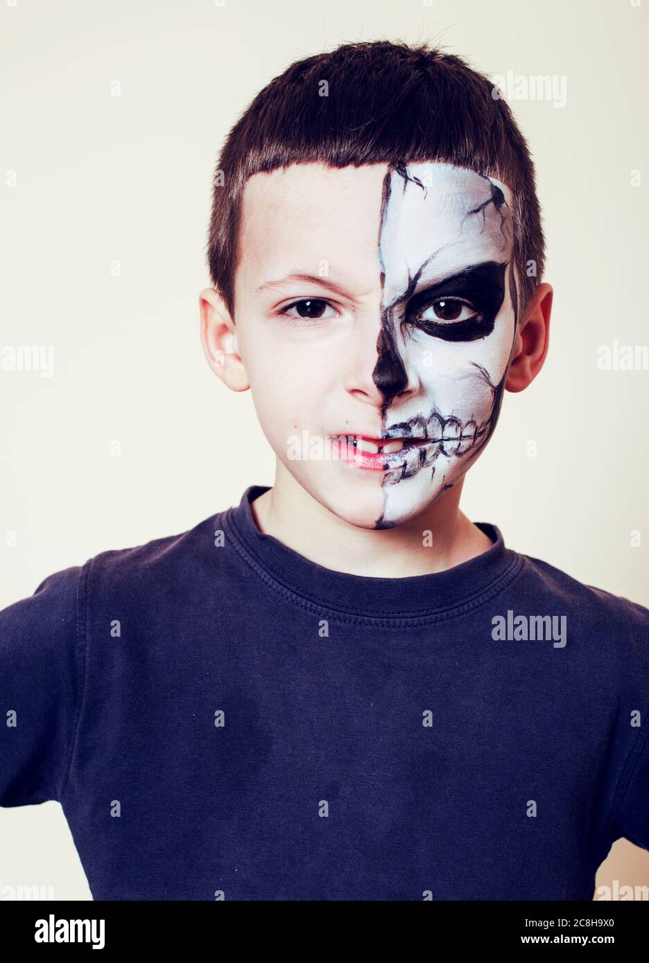 little cute boy with facepaint like skeleton to celebrate halloween ...
