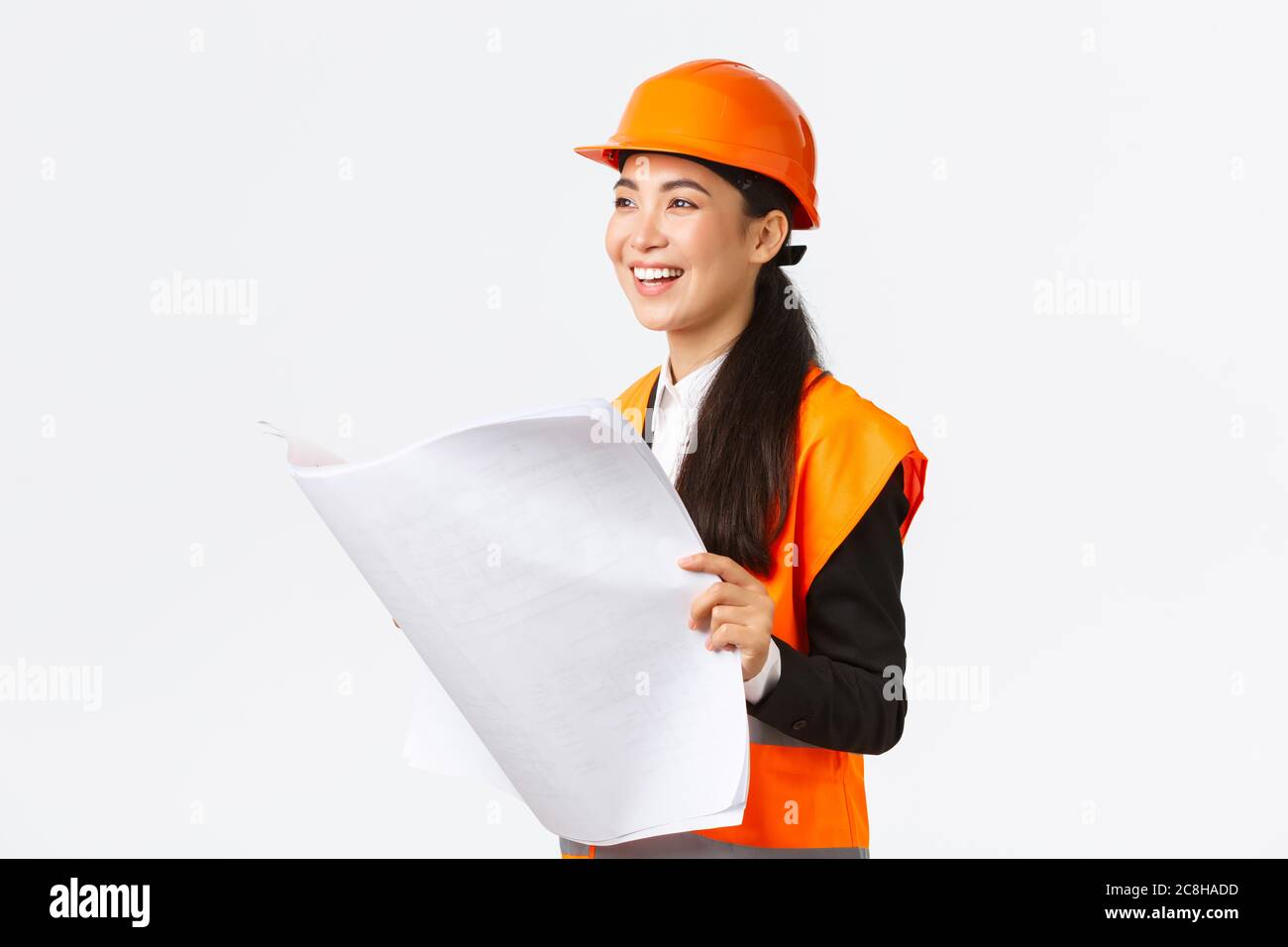 Satisfied happy asian female chief engineer looking at results of ...