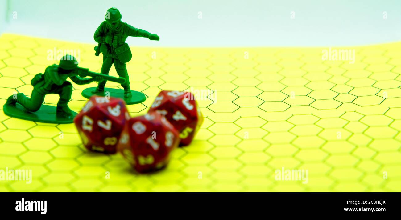 Role-playing board with pentagonal-shaped red dice and plastic figures ...