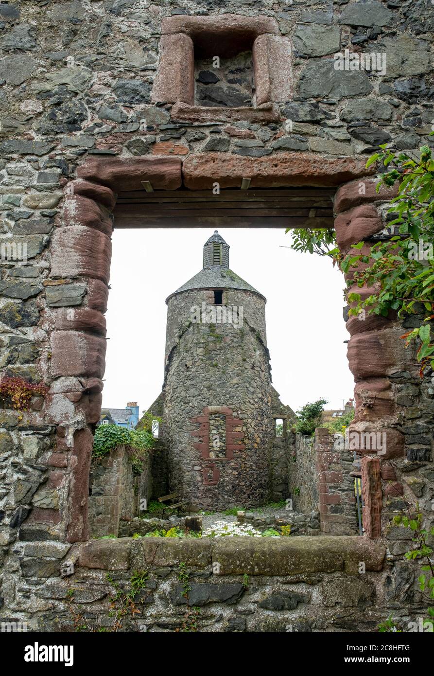 A view looking through a church window of a celtic tower in the ...