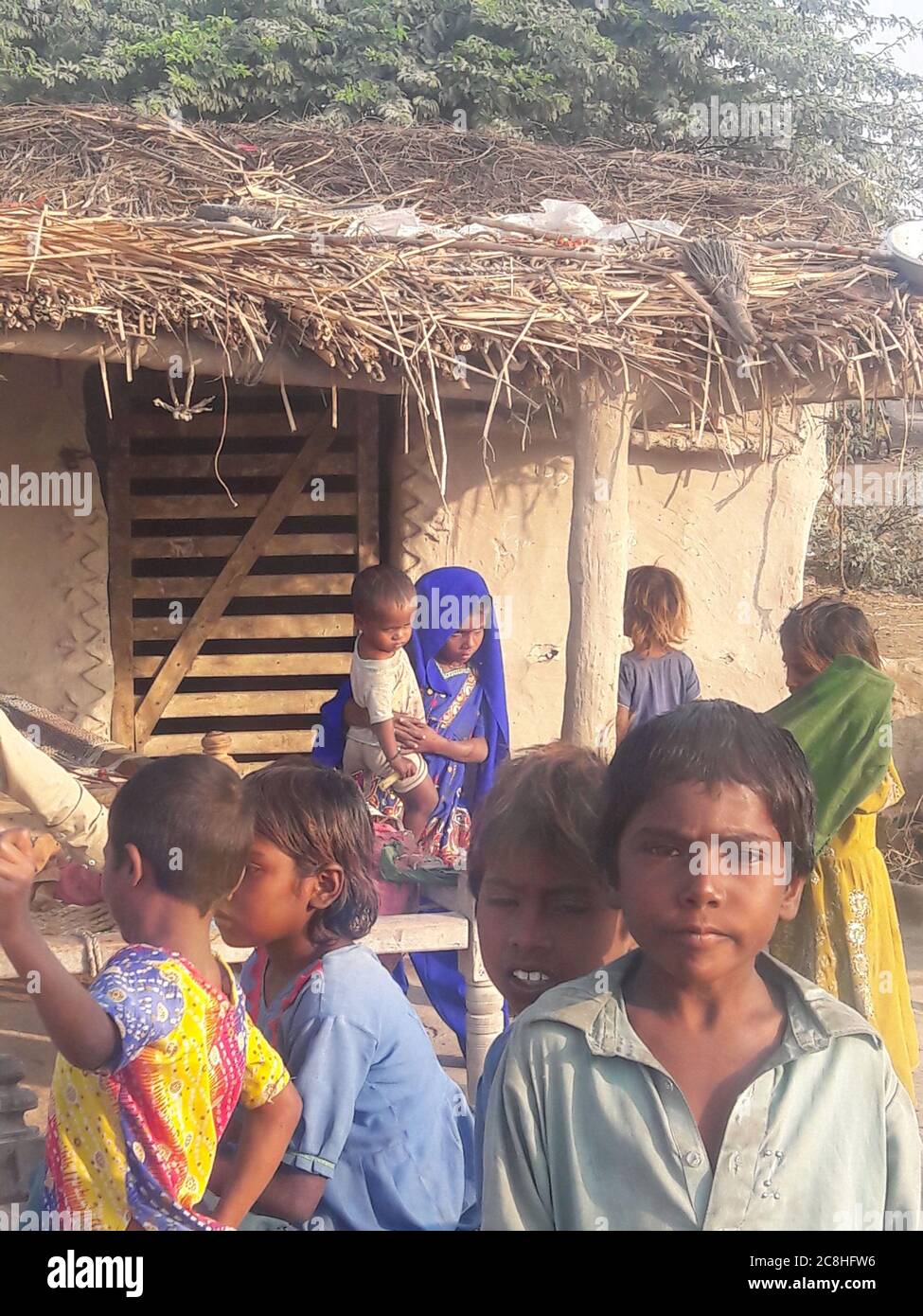 Villagers near their home Stock Photo - Alamy