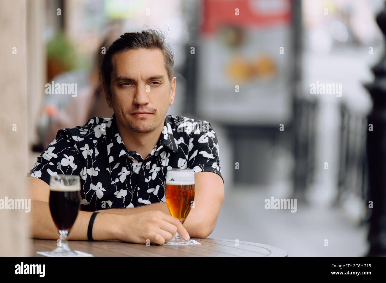 happy attractive man relaxing and having a beer in a pub Stock Photo ...