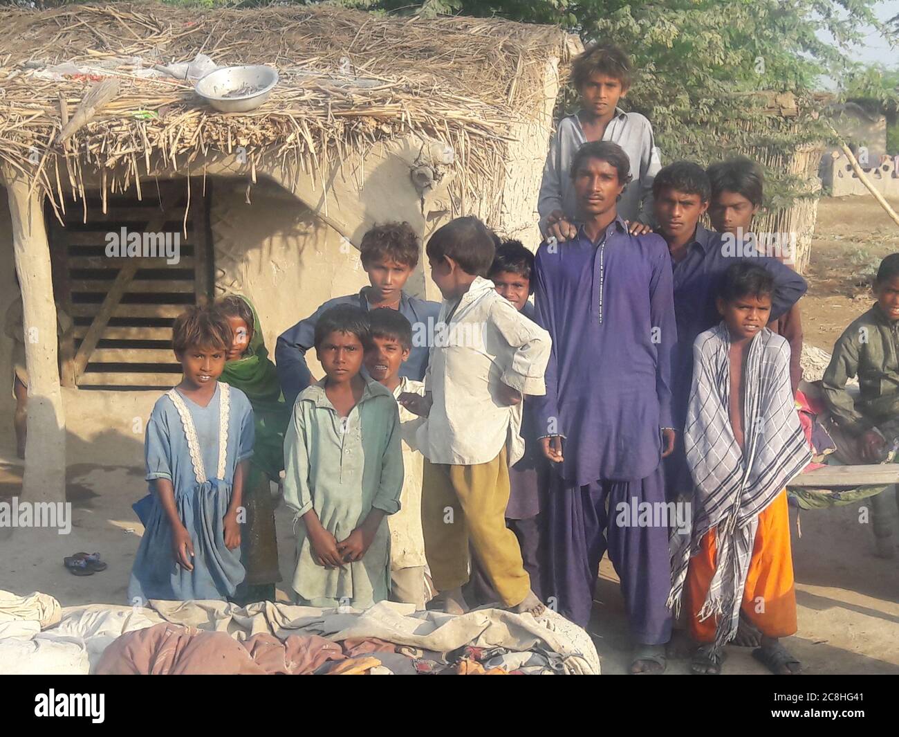 Villagers near their home Stock Photo - Alamy