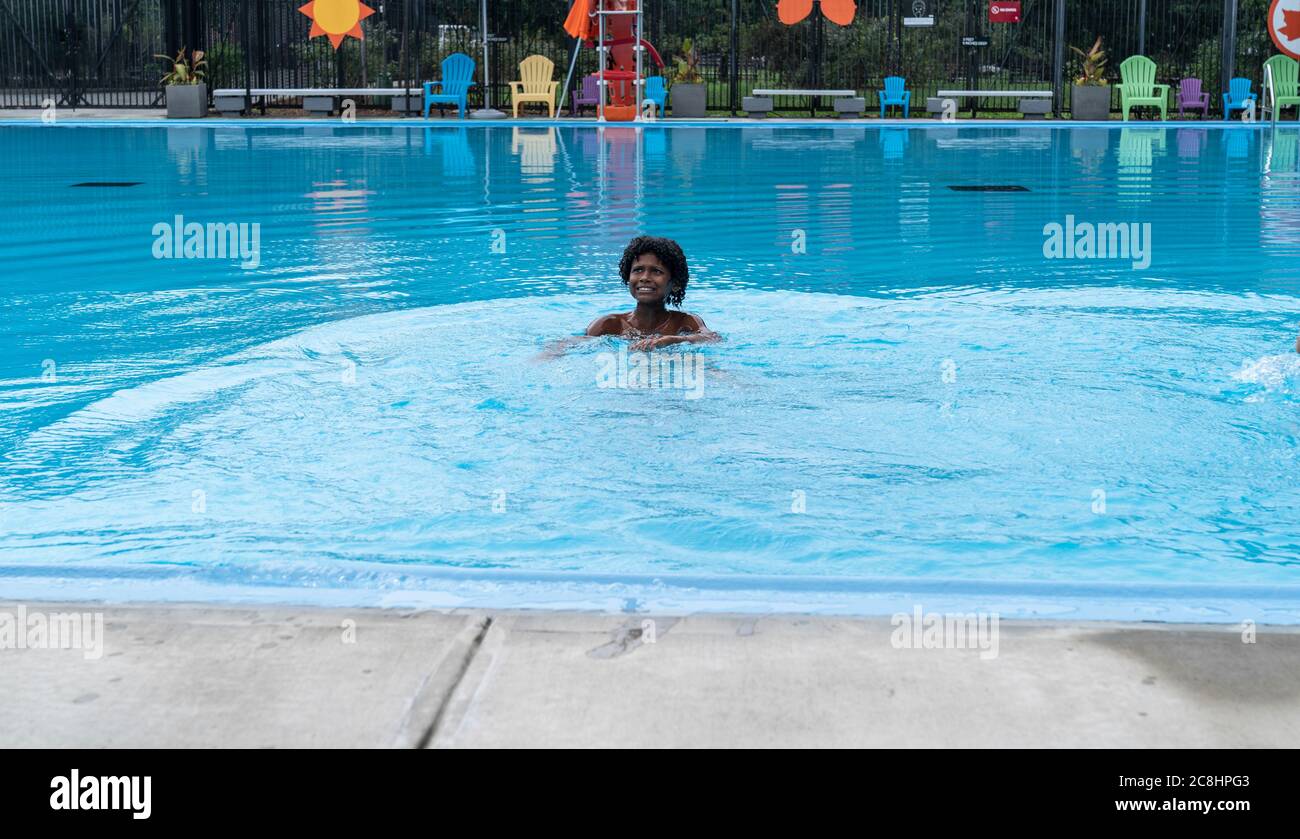 New York, NY - July 24, 2020: People seen enjoying swimming and play on ...