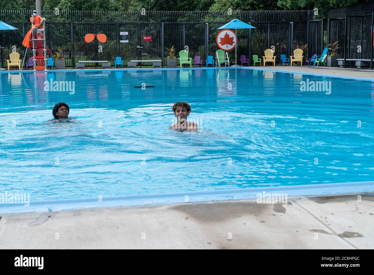 New York, NY - July 24, 2020: People seen enjoying swimming and play on ...
