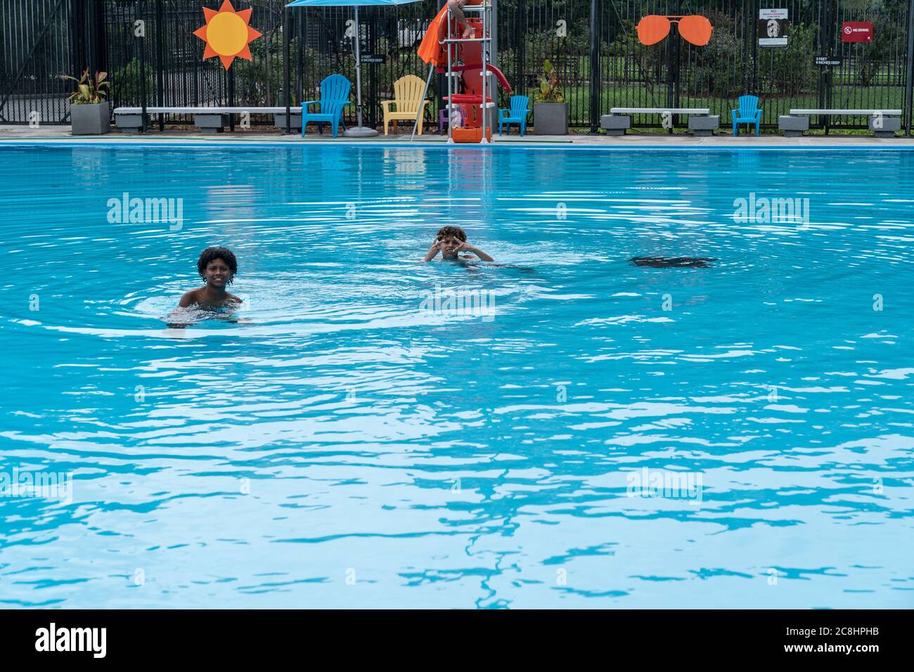 New York, NY - July 24, 2020: People seen enjoying swimming and play on ...
