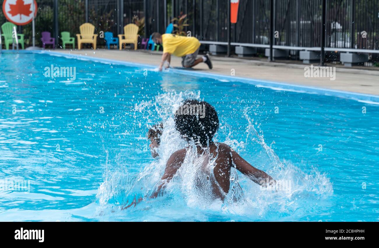 New York, NY - July 24, 2020: People seen enjoying swimming and play on ...
