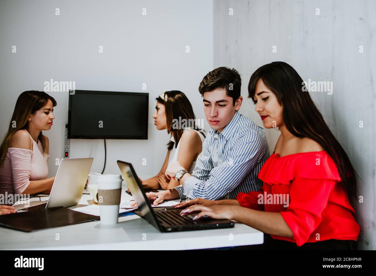 latin people at office working with computer, Group of young Mexican ...
