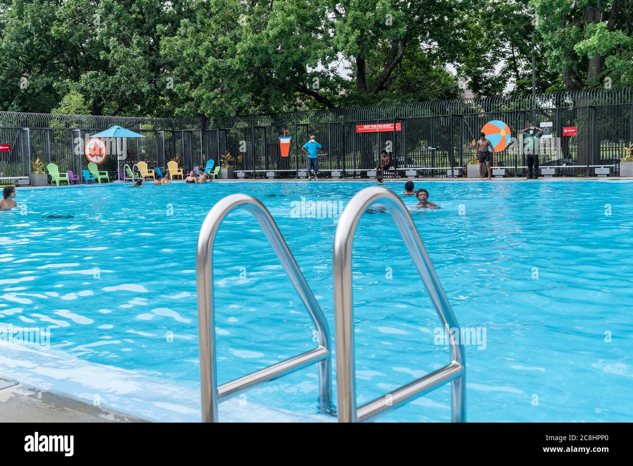 New York, NY - July 24, 2020: People seen enjoying swimming and play on ...