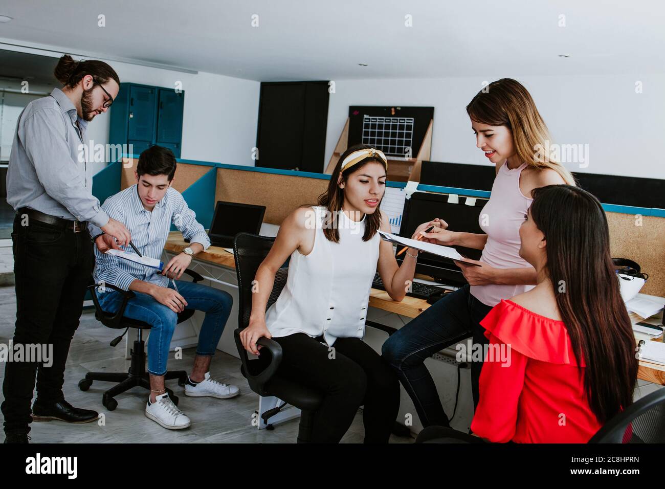latin people at office working with computer, Group of young Mexican ...