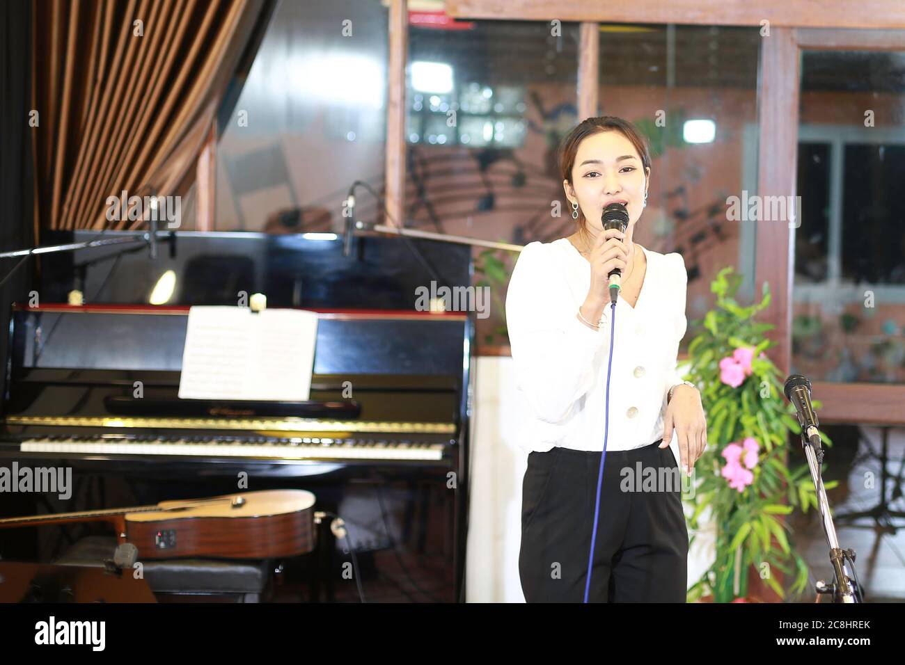 A beautiful Asian female singer is singing in the studio Stock Photo ...