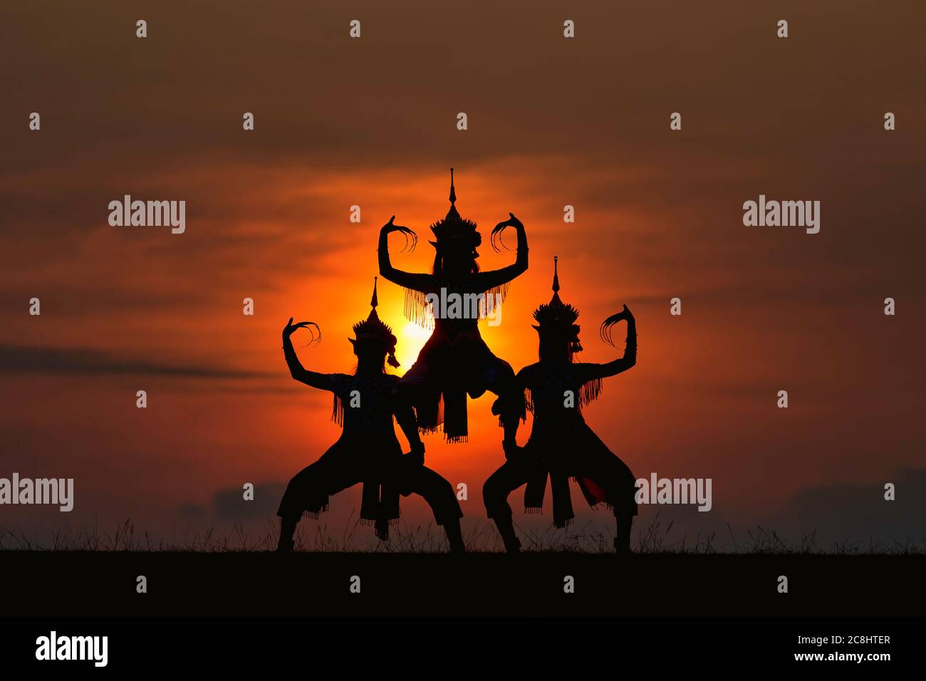 The black silhouette of three Manohra actors dancing in the park in the ...