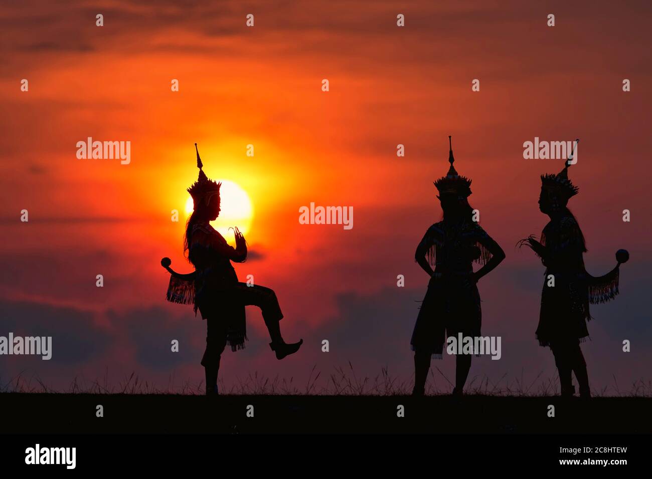 The black silhouette of three Manohra actors dancing in the park in the ...