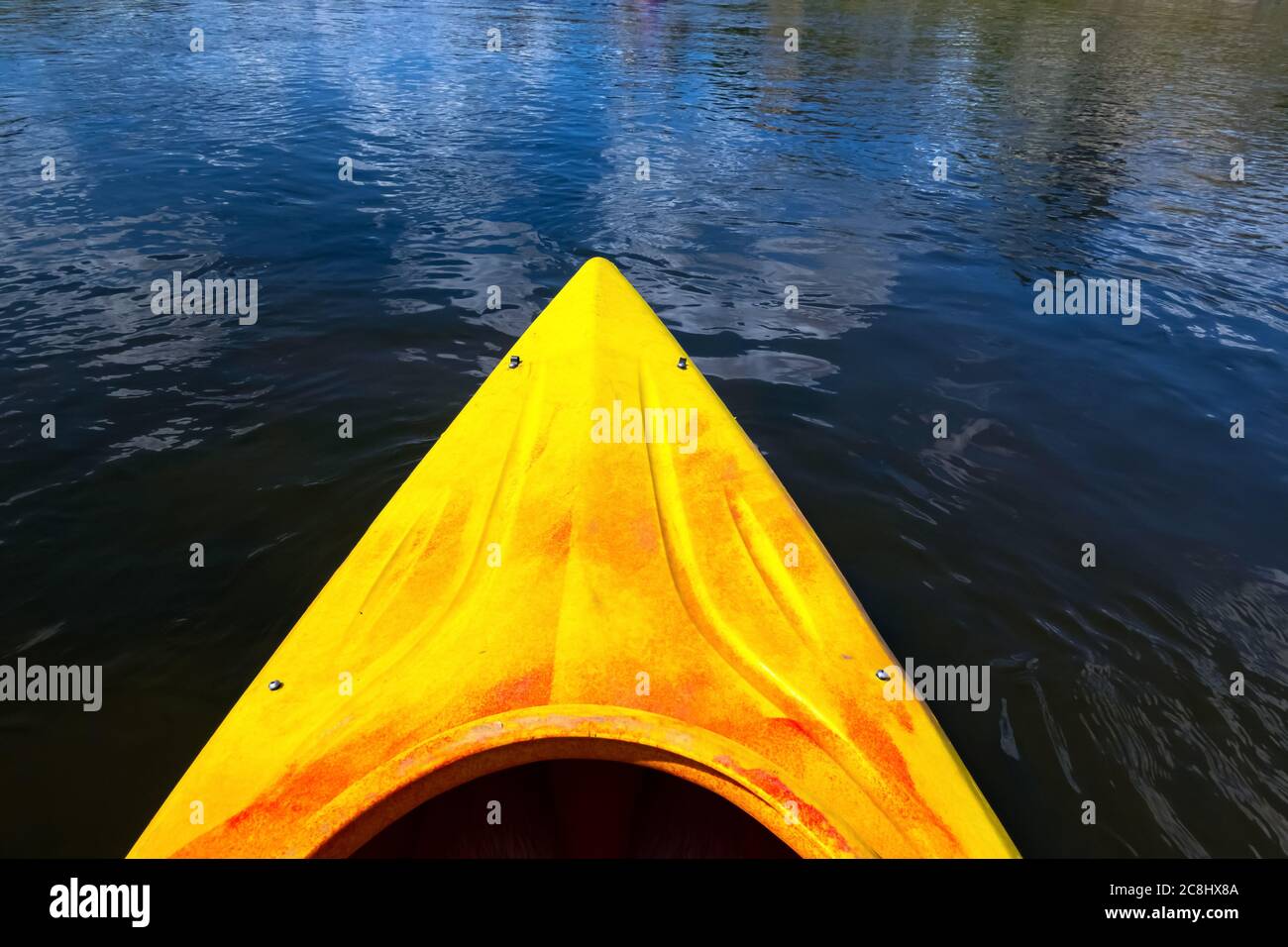 Close up shot of a tip of canoe in the river on a sunny day. Exploring ...