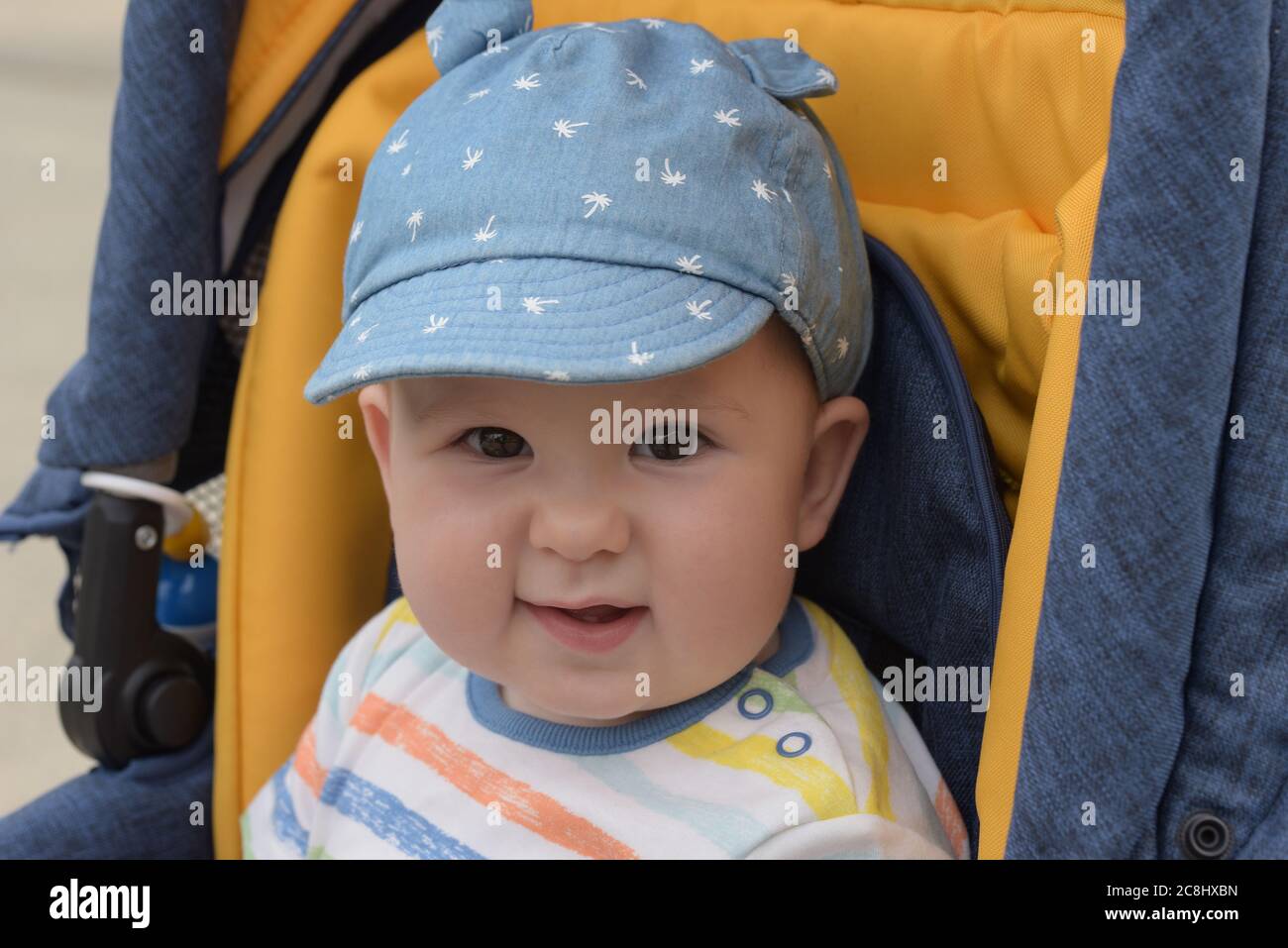 Baby sitting in stroller. Face of little boy Stock Photo - Alamy